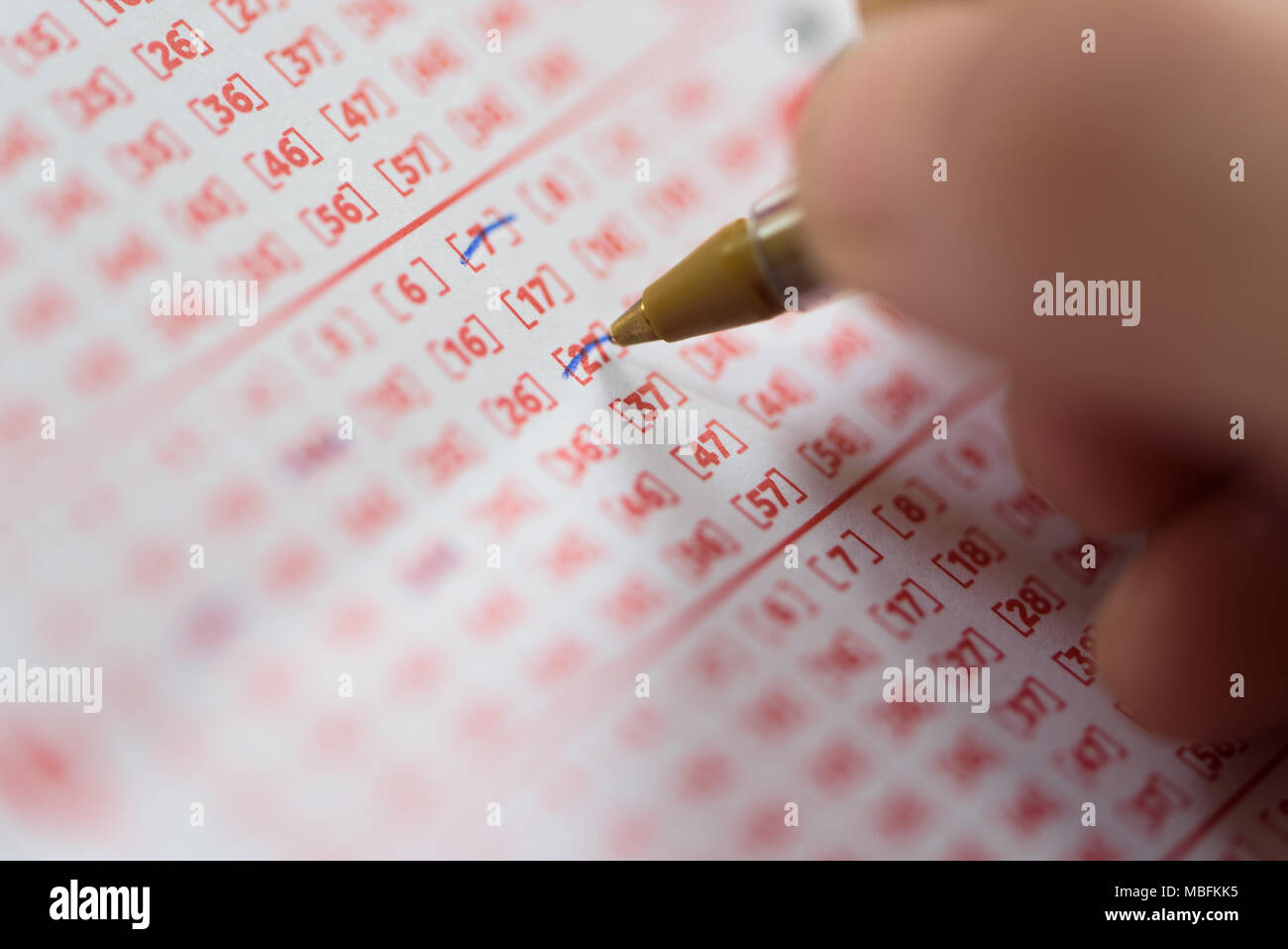 Close-up Of Person's Hand Marking Number On Lottery Ticket With Pen ...
