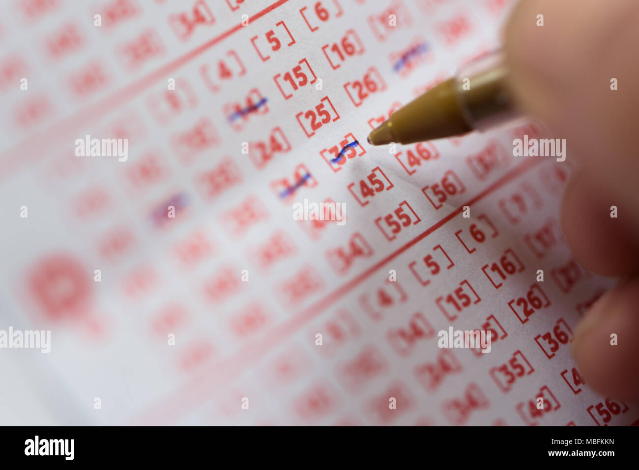 Close-up Of Person's Hand Marking Number On Lottery Ticket With Pen ...