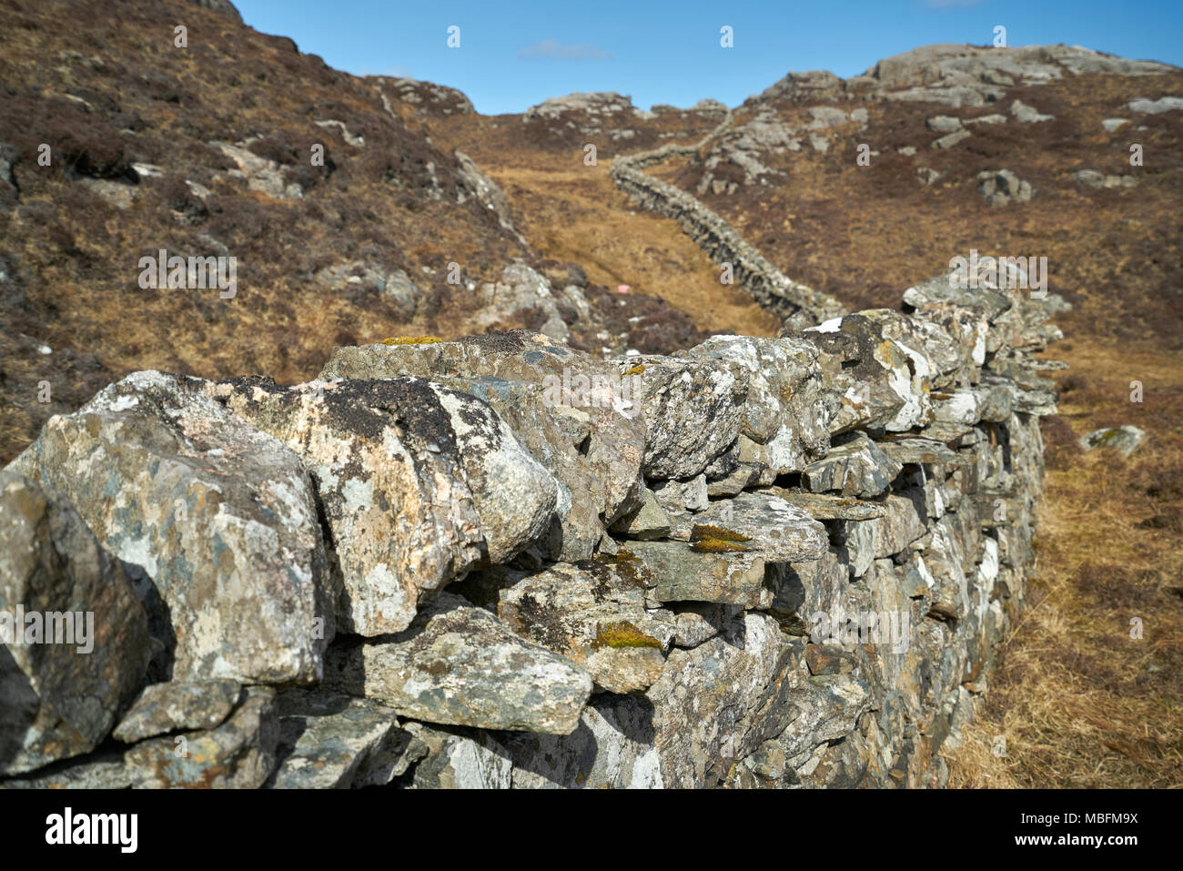 Unusual stone wall built of granite boulders winds it's way through the ...