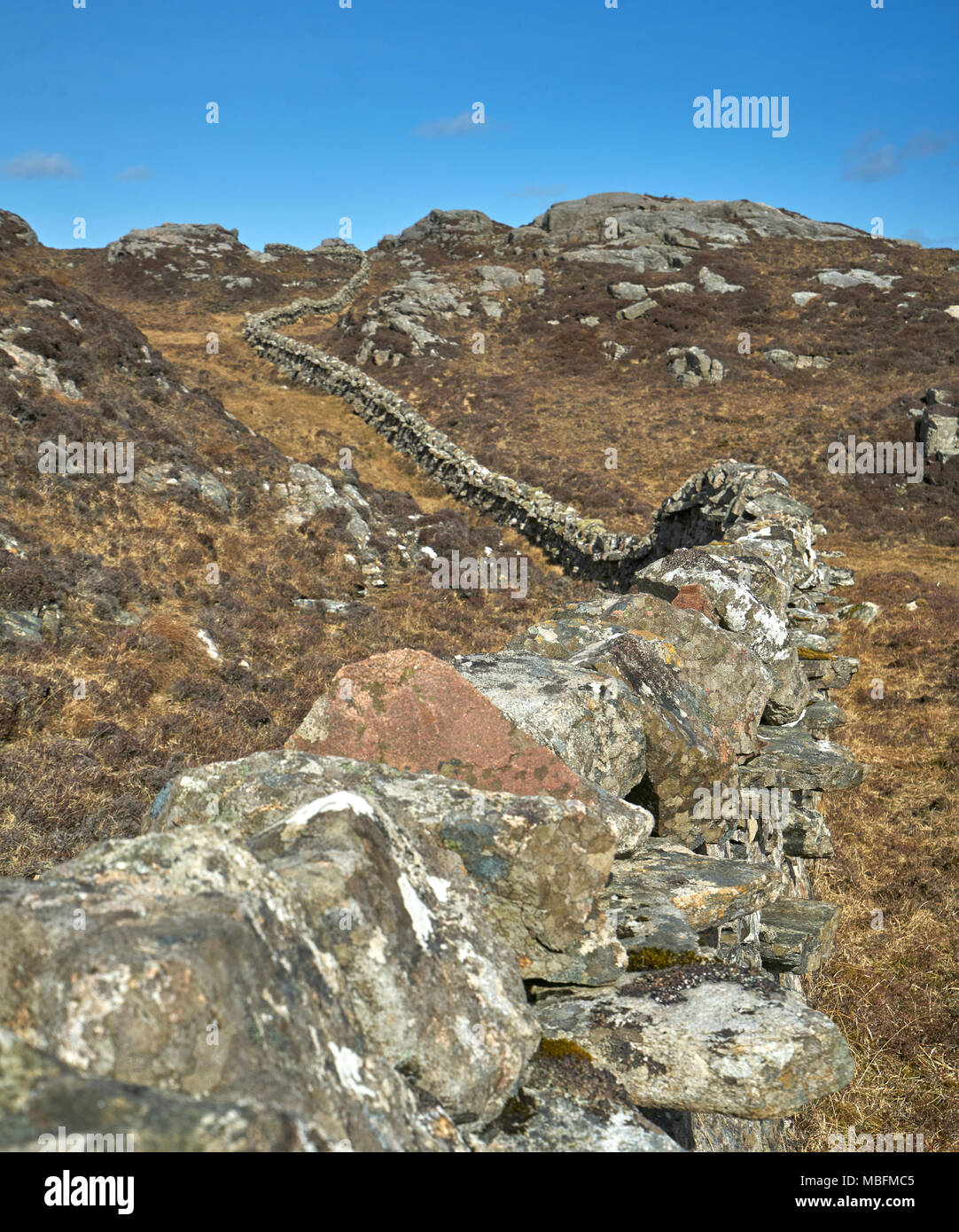 Unusual stone wall constructed of granite boulders winds its way ...