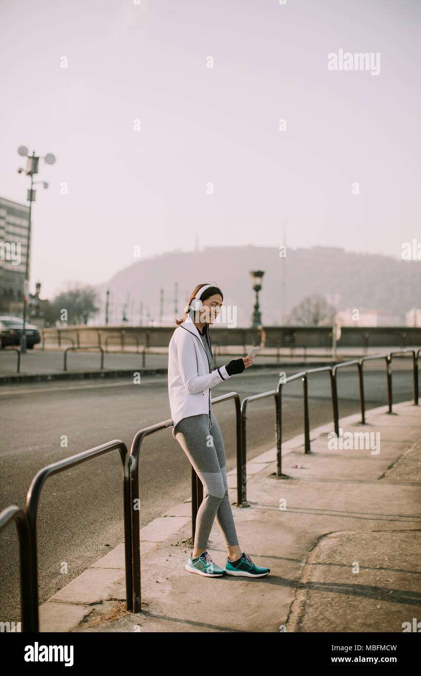 Young female athlete taking break from running workout outdoor Stock ...