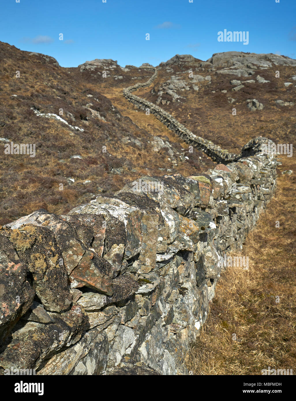 Unusual stone wall constructed of granite boulders winds its way ...