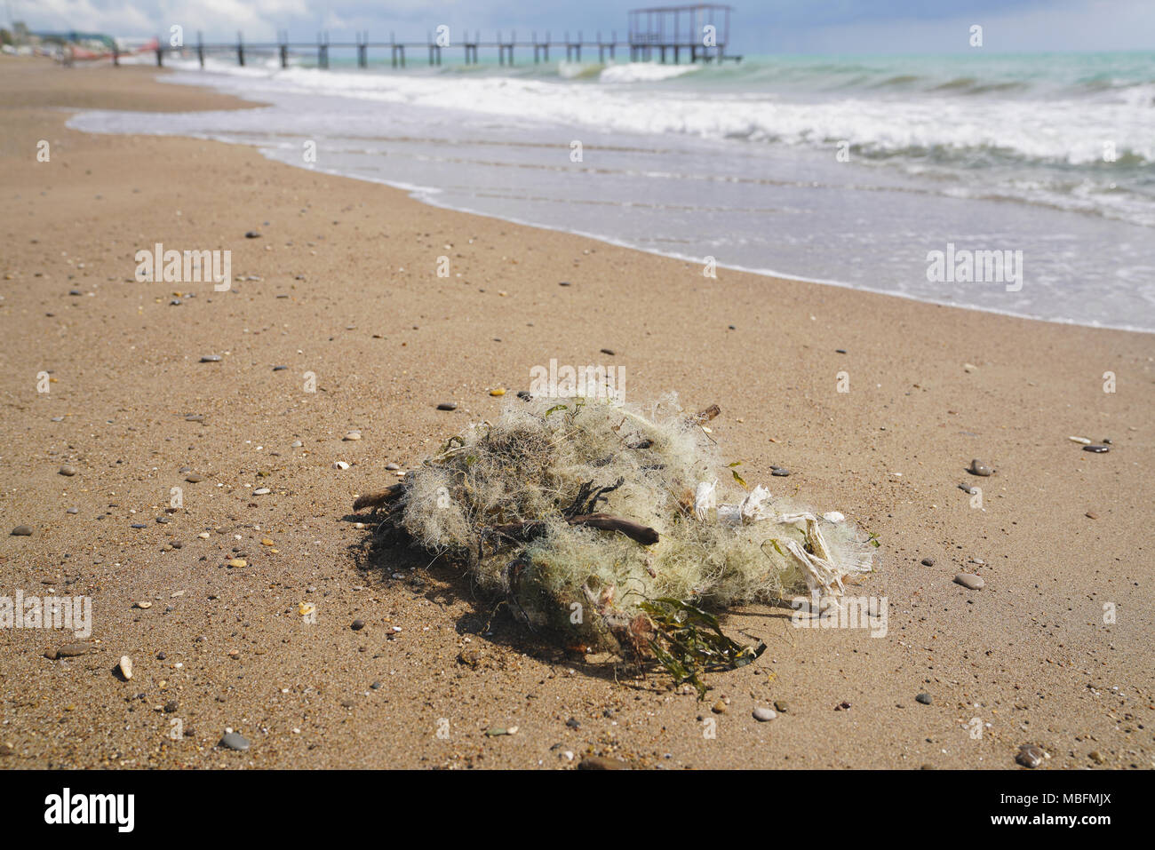 Trash (net and litter) at the Mediterranean sea beach and pier on ...