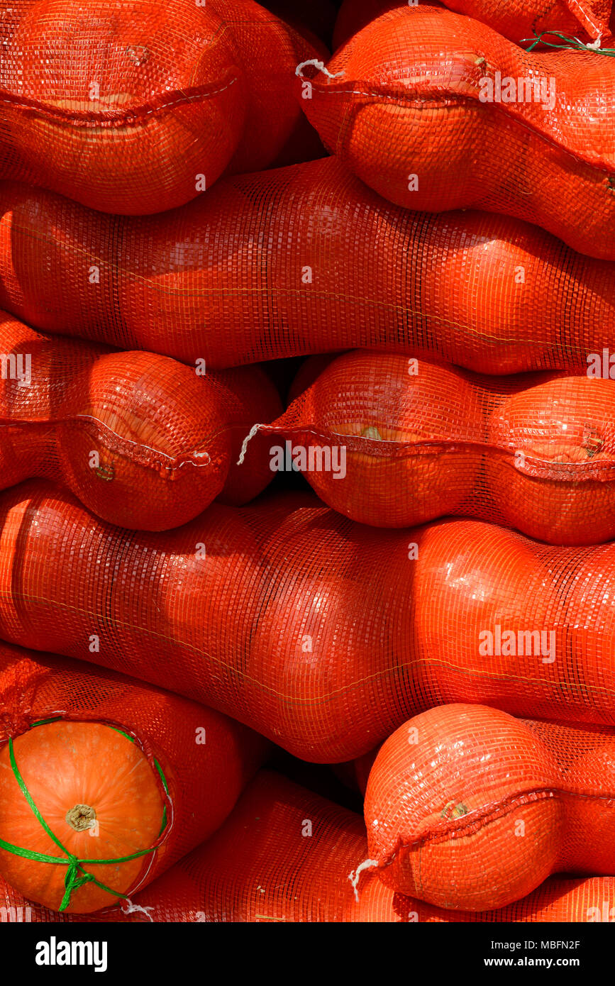 Bulging bags of gourds for sale outside a grocers store in Jinding area ...