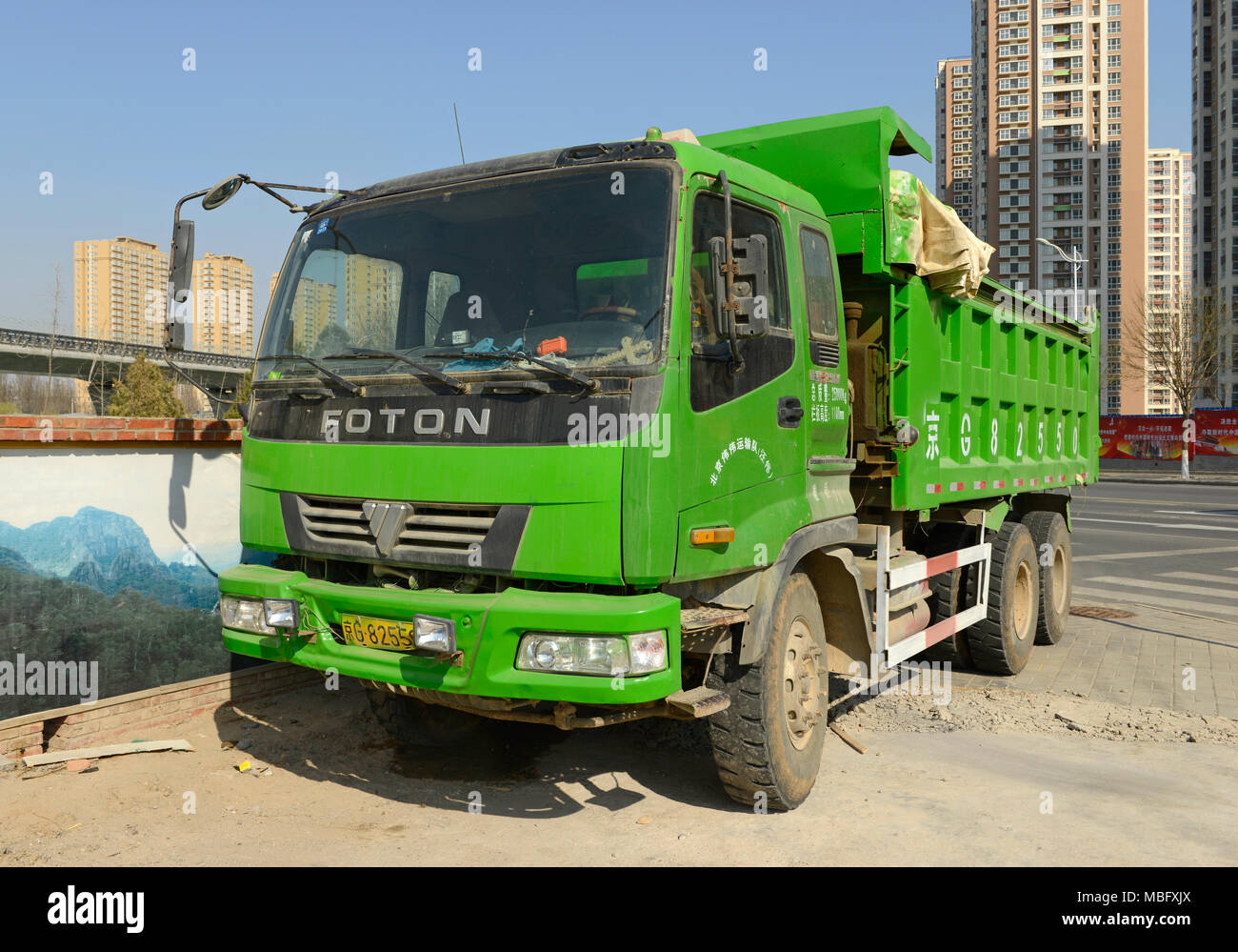 Green Foton marque tipper truck near a building site in western Beijing ...