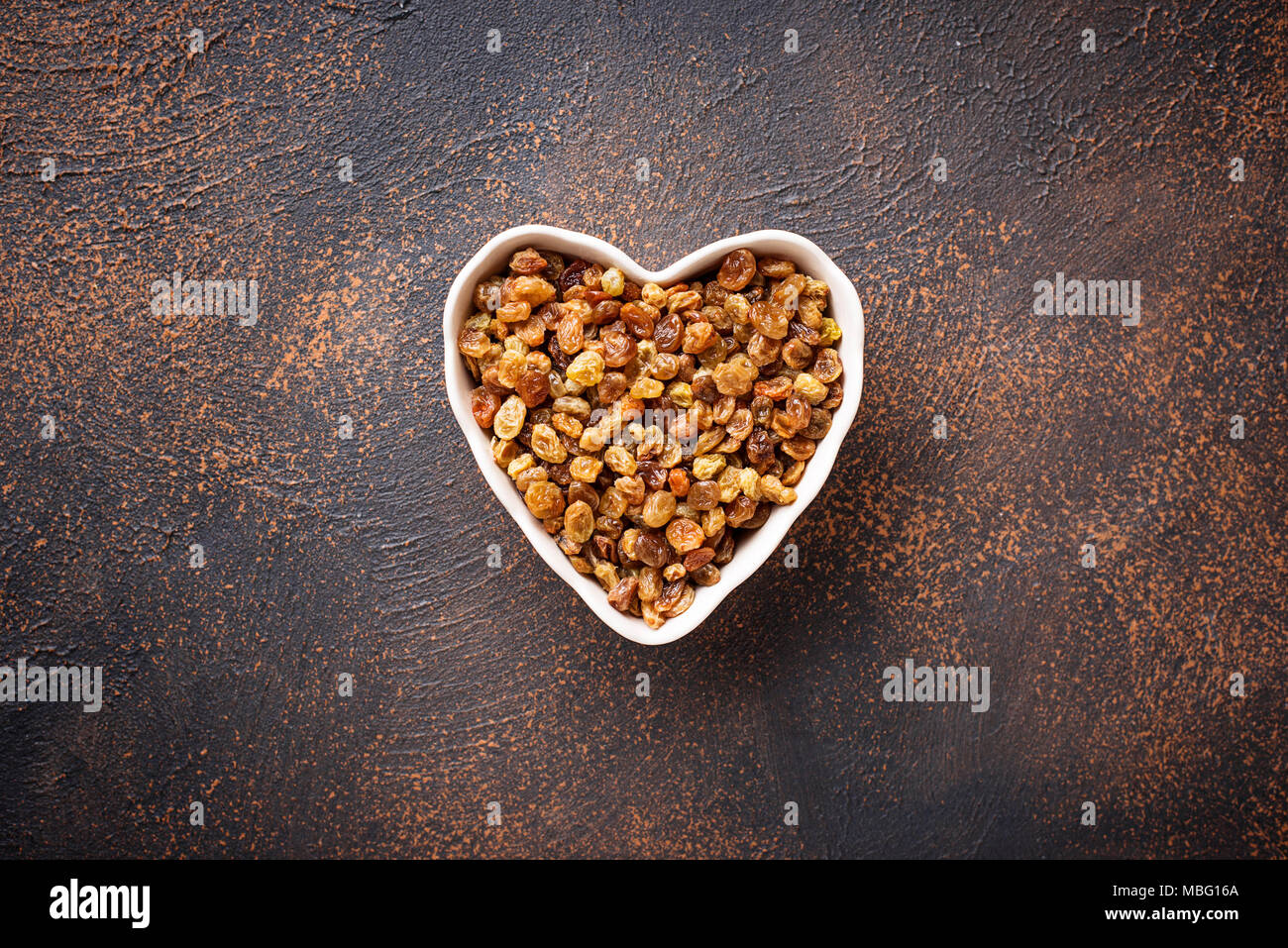 Raisins in heart shape bowl Stock Photo - Alamy