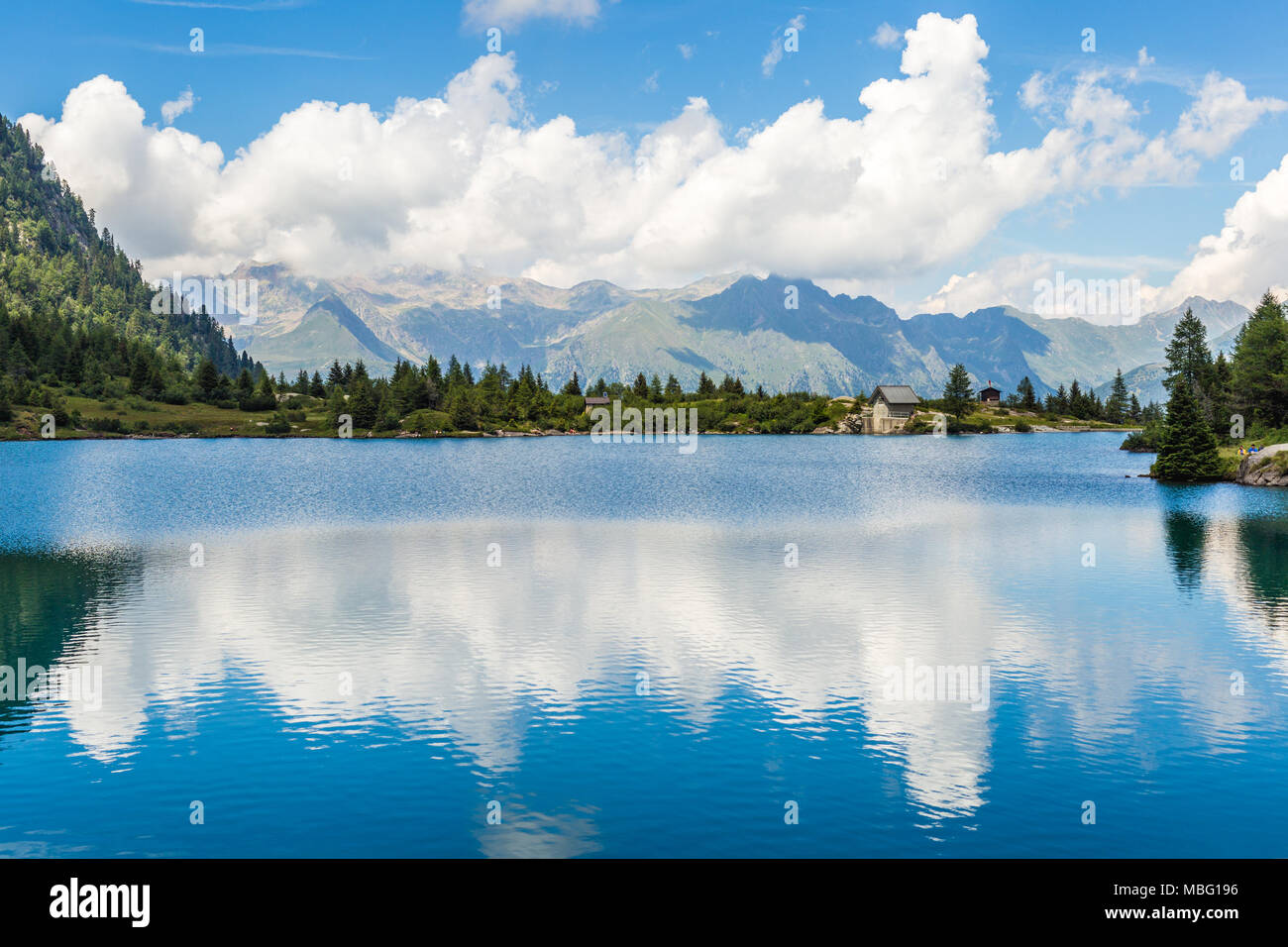 Cloud reflecting on the Aviolo Lake in a summer day. Edolo, Italy Stock ...