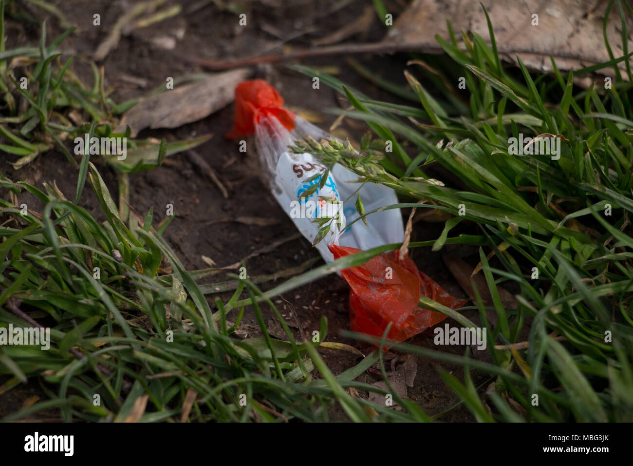 Kinder wrapping on the ground Stock Photo - Alamy