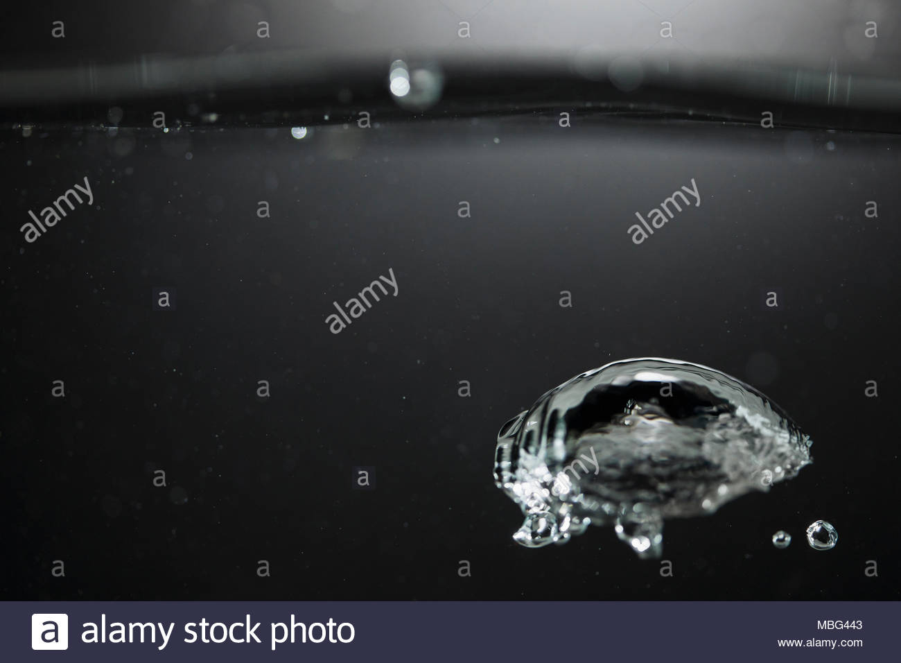 Water droplet rising to the surface Stock Photo - Alamy