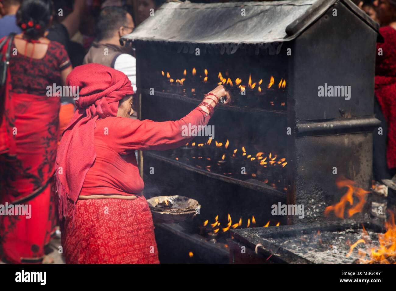 Old lady lighting butter lamps at Swayambunath monkey temple, Kathmandu ...