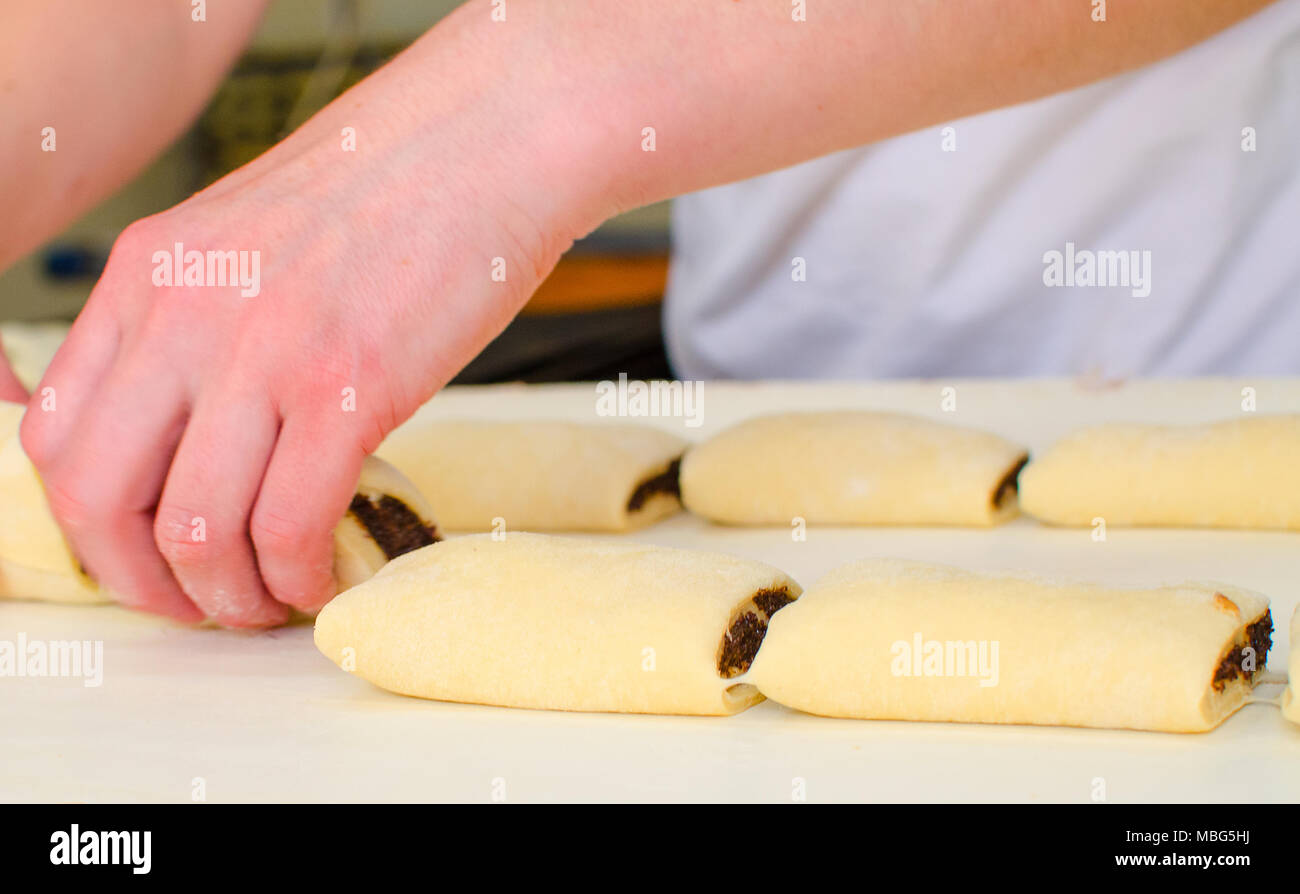 Working on a sweet pastry in a big industrial bakery Stock Photo - Alamy