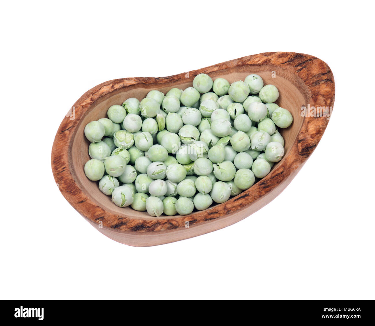 Natural crunchy dried peas in olive wood bowl isolated on white ...