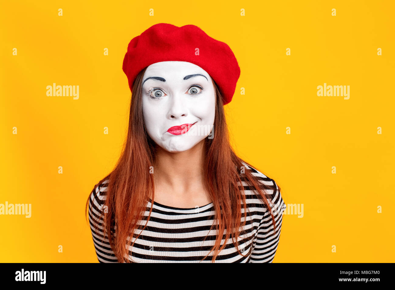 Closeup portrait of wondered mime woman in striped jacket. Emotions and ...