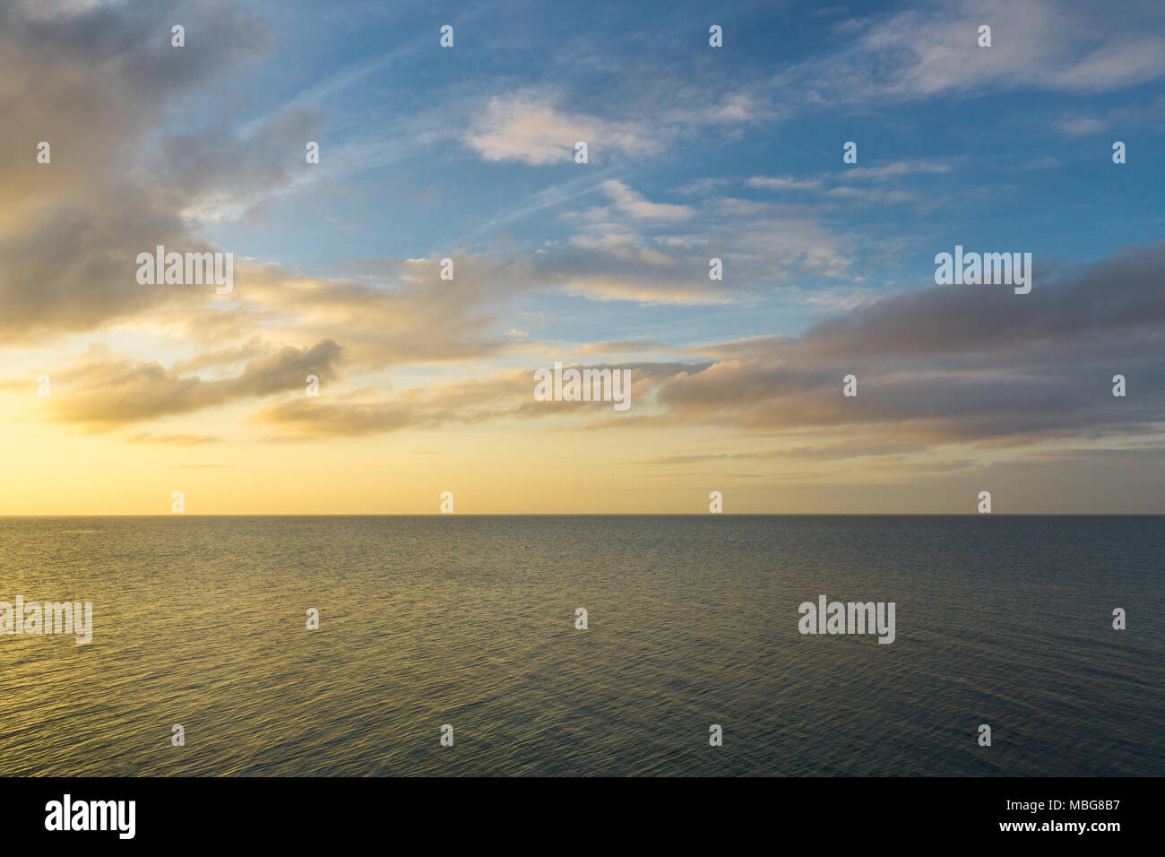 USA, Florida, Romantic orange sunset sky over the ocean water at ...
