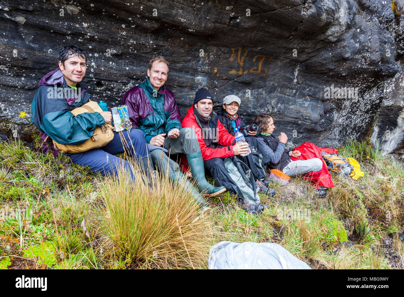 EL ALTAR, ECUADOR - MARCH 08: Group of hikers walking around the crater ...