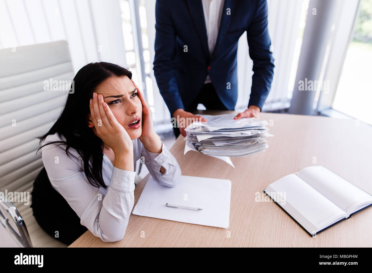 Businesswoman having headache for having too much work to get done from ...