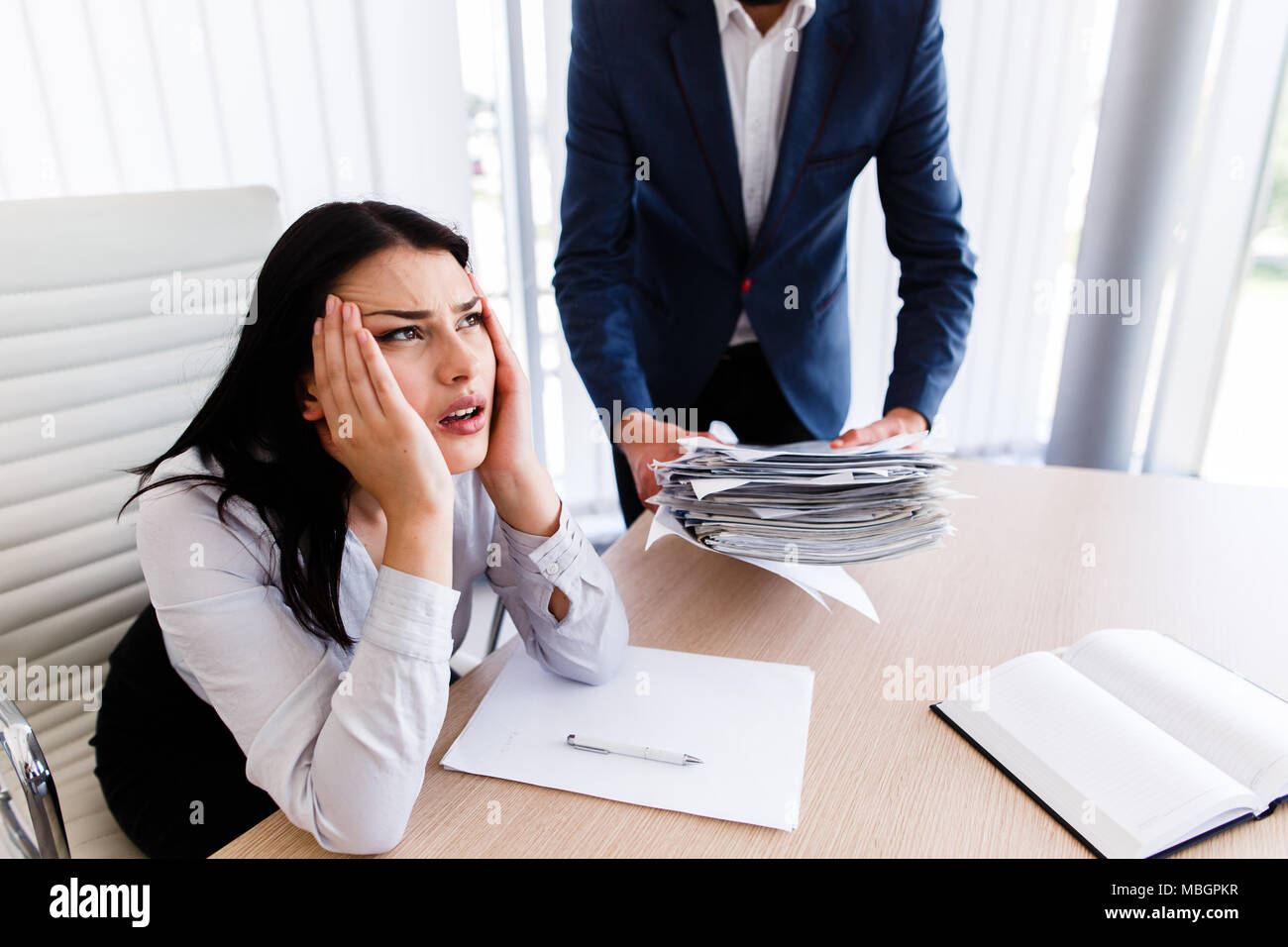 Businesswoman having headache for having too much work to get done from ...
