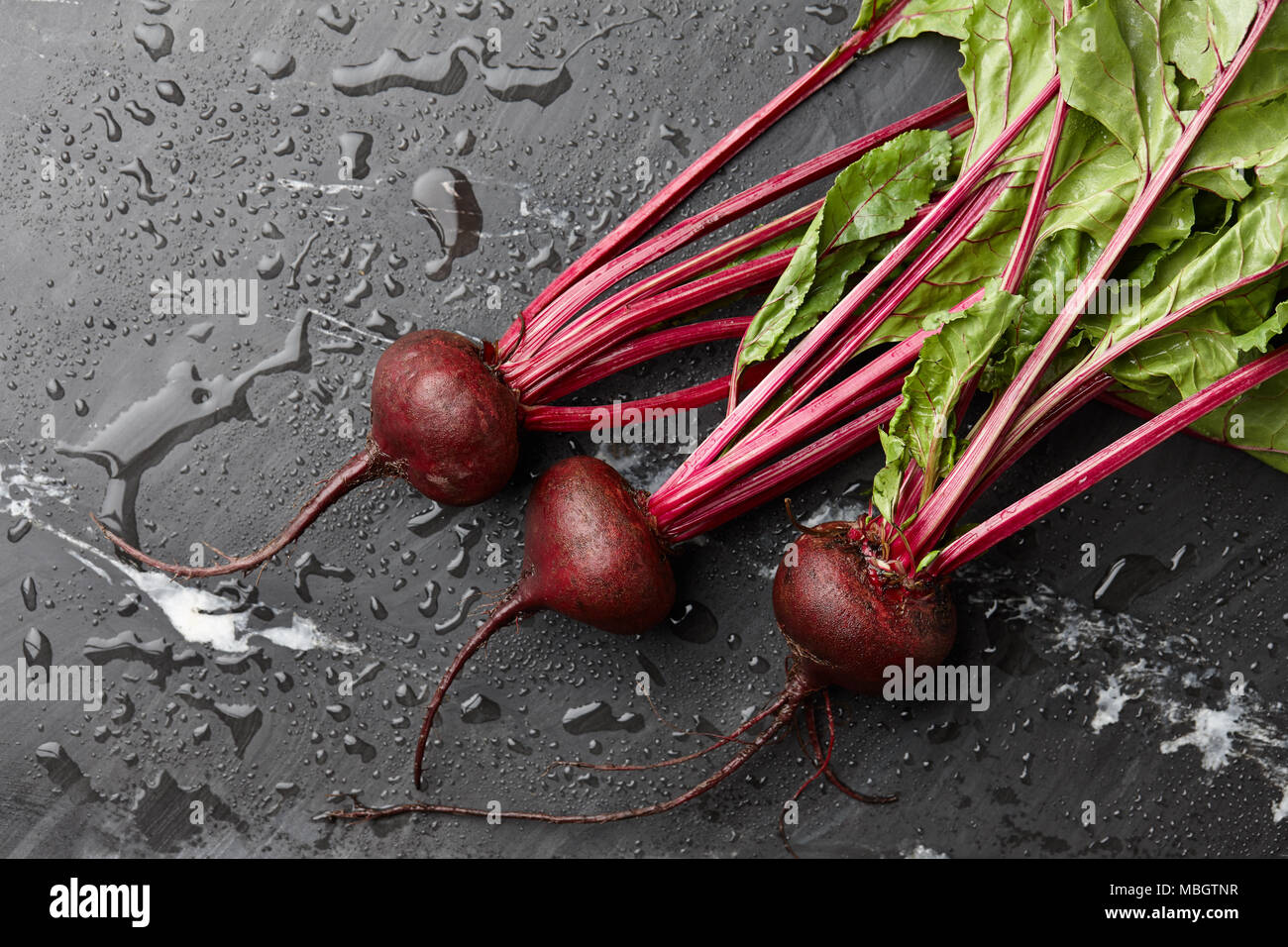 Fresh harvested beetroot on stone background, top view Stock Photo - Alamy