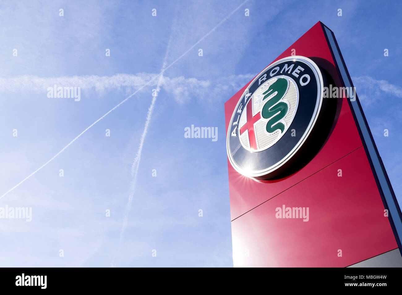Alfa Romeo dealership sign against blue sky. The brand is known for ...