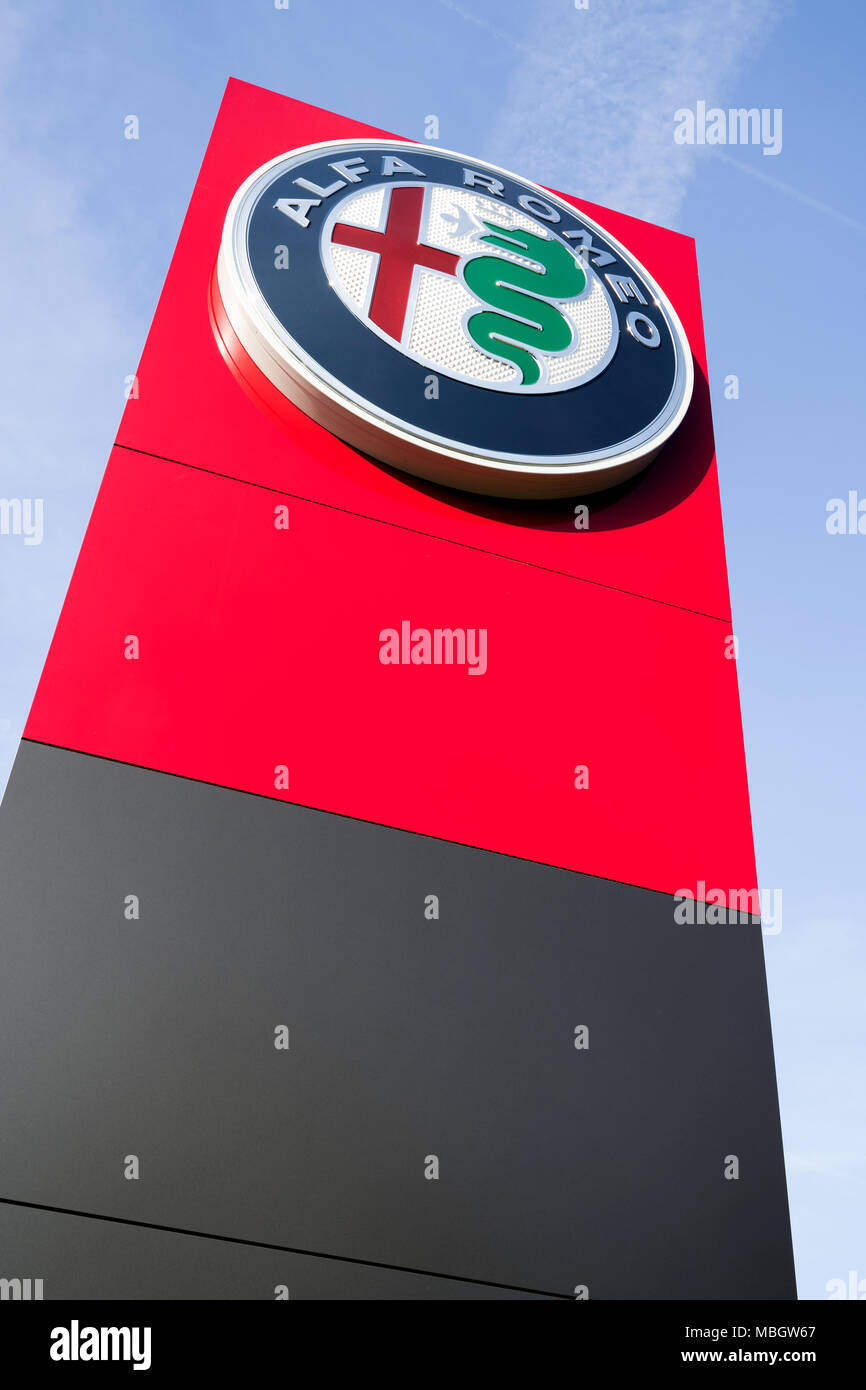 Alfa Romeo dealership sign against blue sky. The brand is known for ...