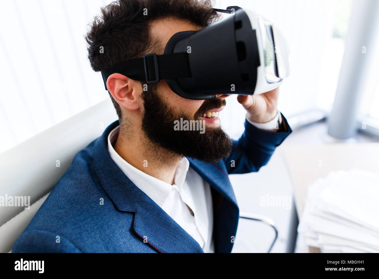 Young Businessman Using VR At Workplace Stock Photo - Alamy