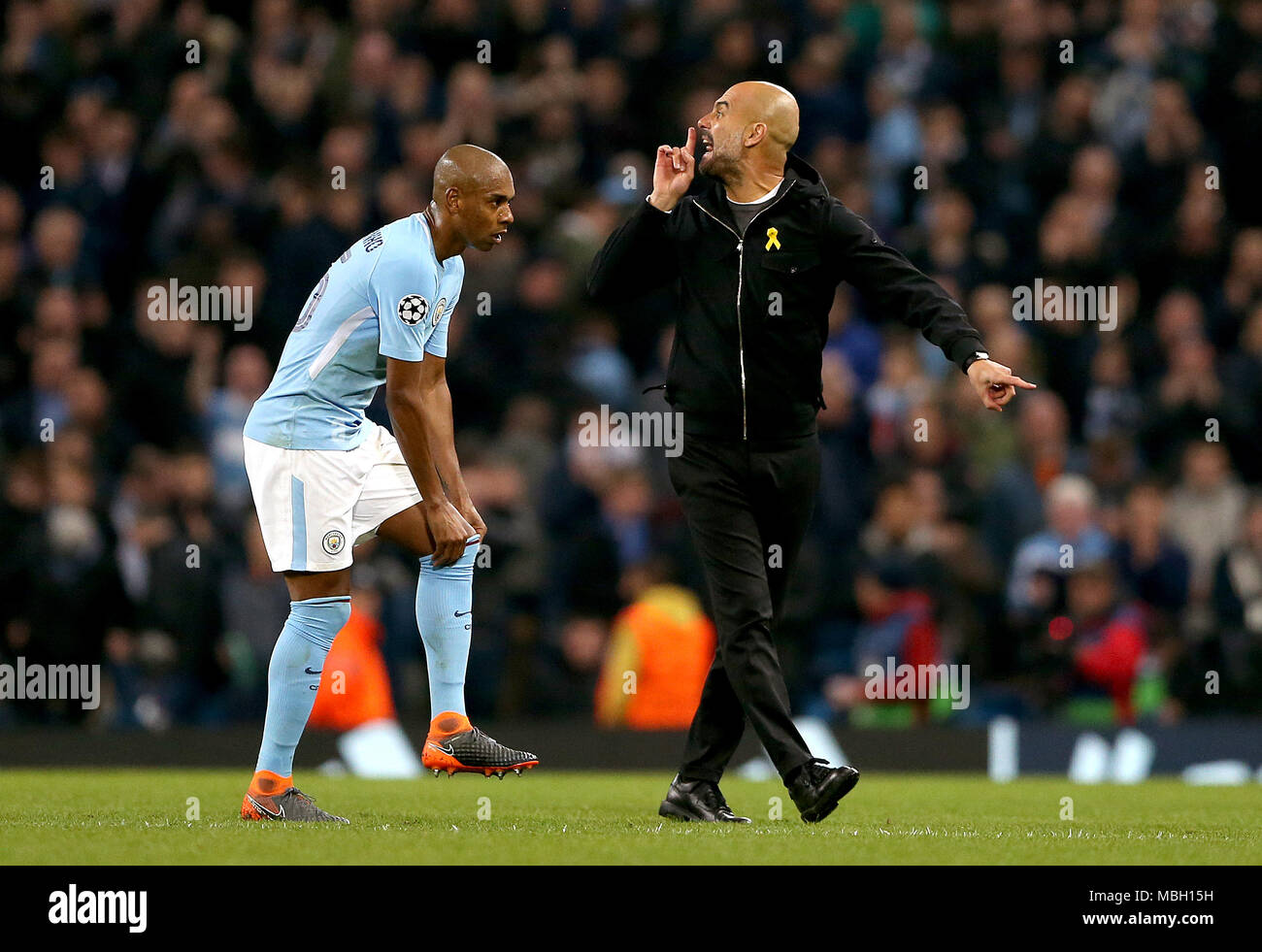 Manchester City manager Pep Guardiola (right) speaks to the match ...