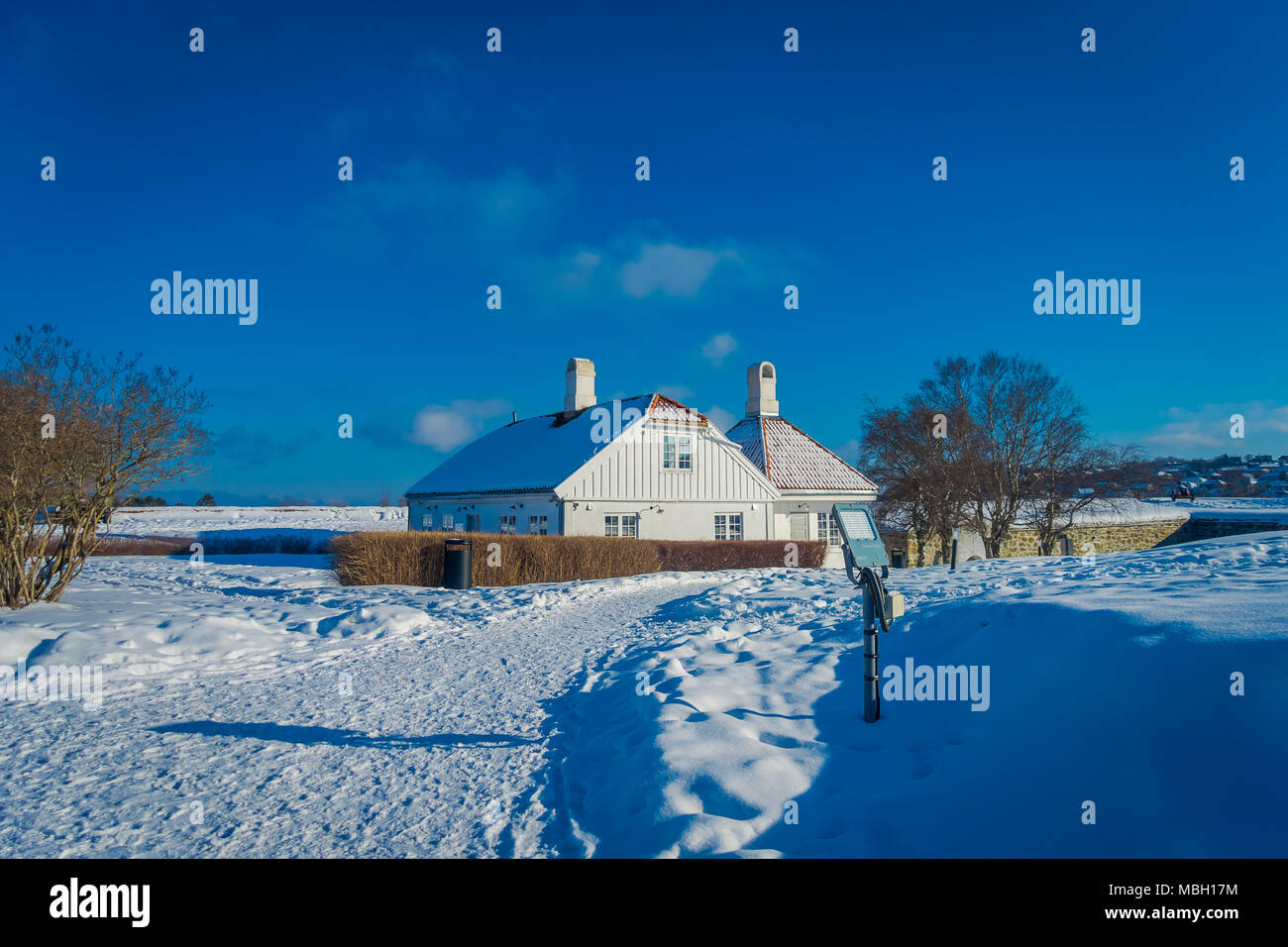Sunny outdoor view of buildings covered with snow during winter at the ...