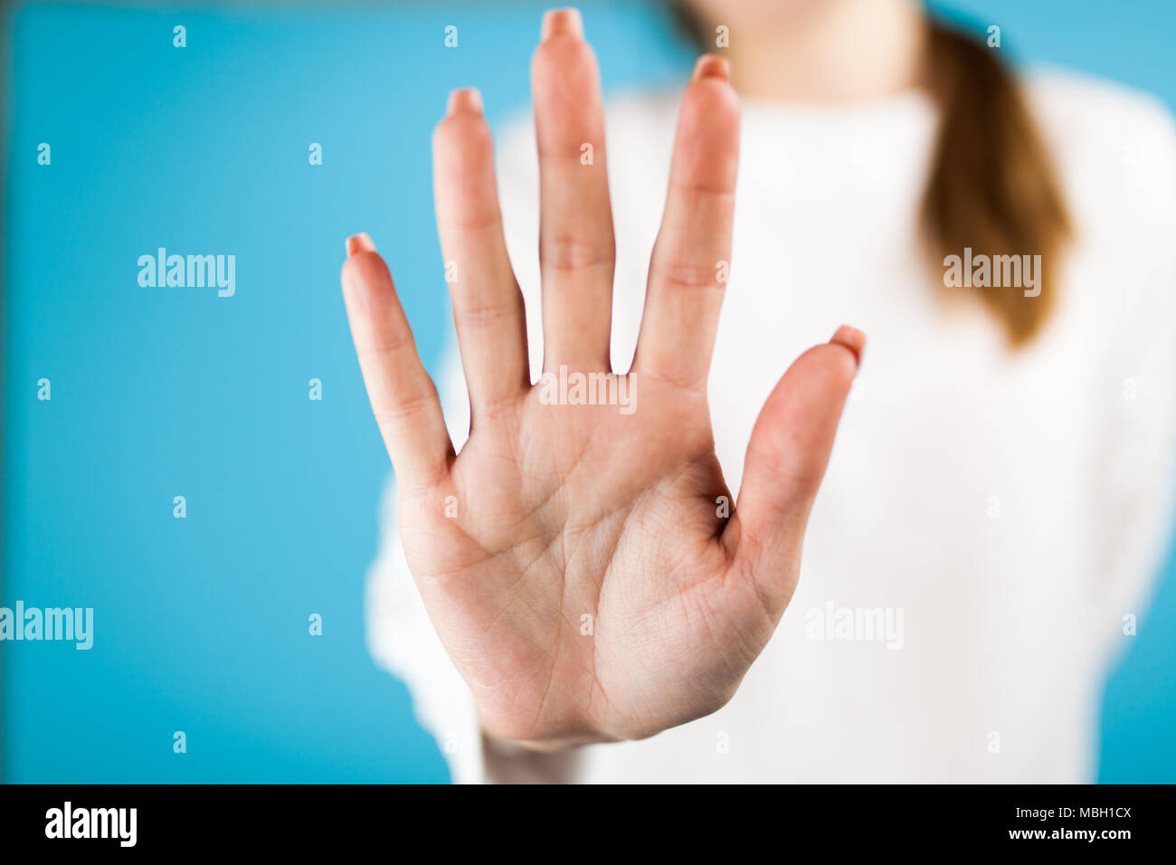 Woman showing stop sign with her hand Stock Photo - Alamy