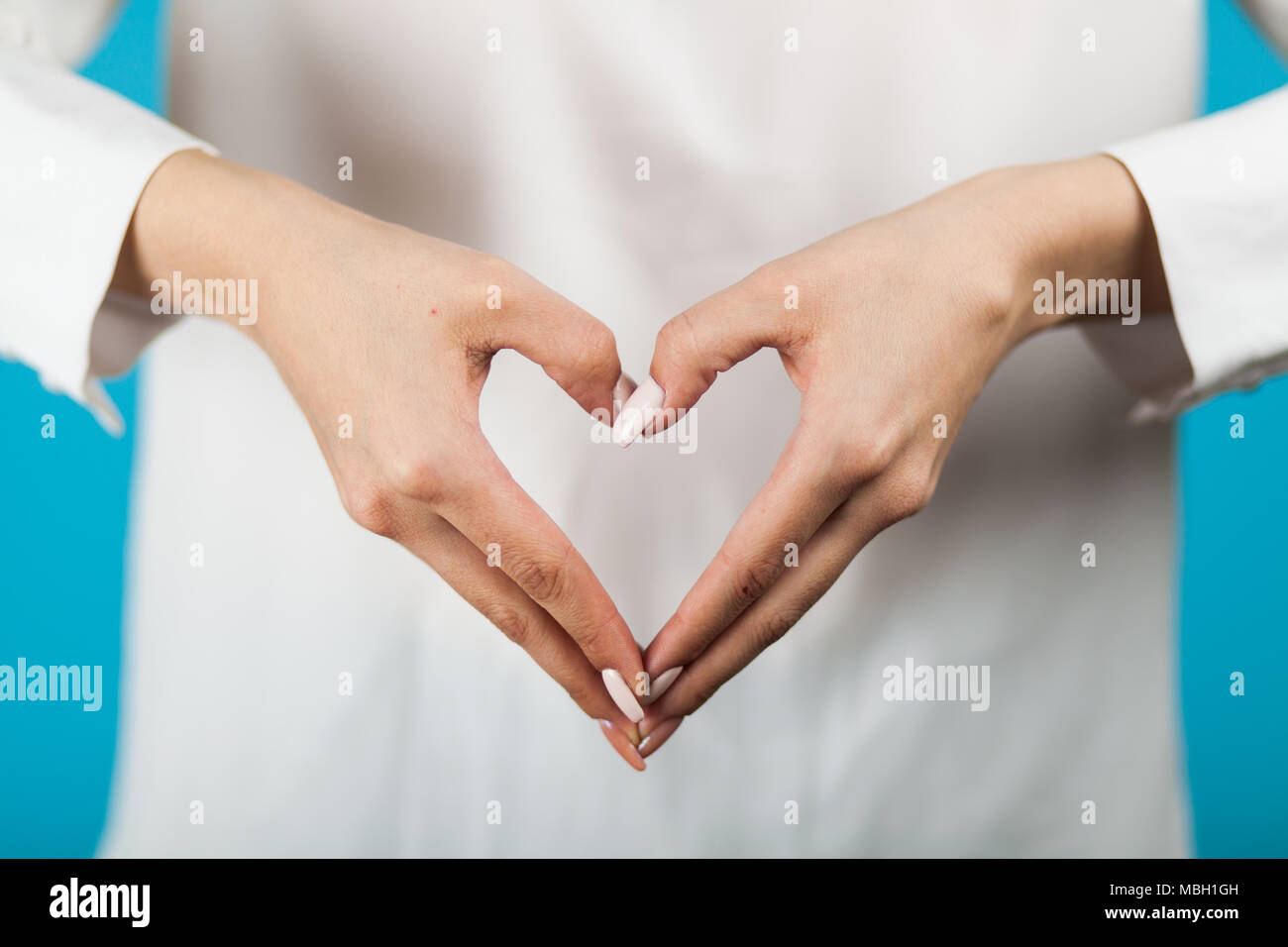 Female hands showing heart sign Stock Photo - Alamy