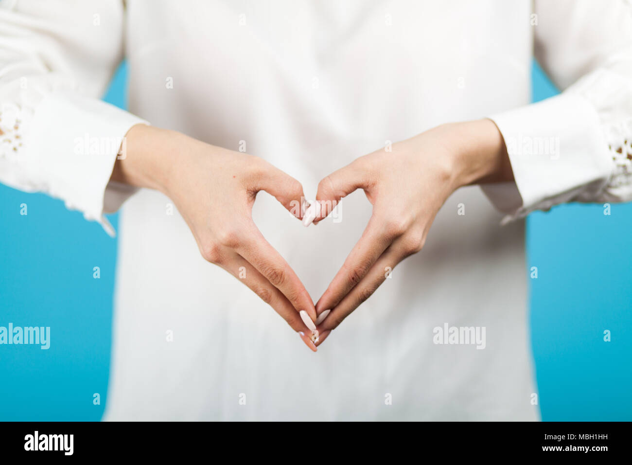 Female hands showing heart sign Stock Photo - Alamy