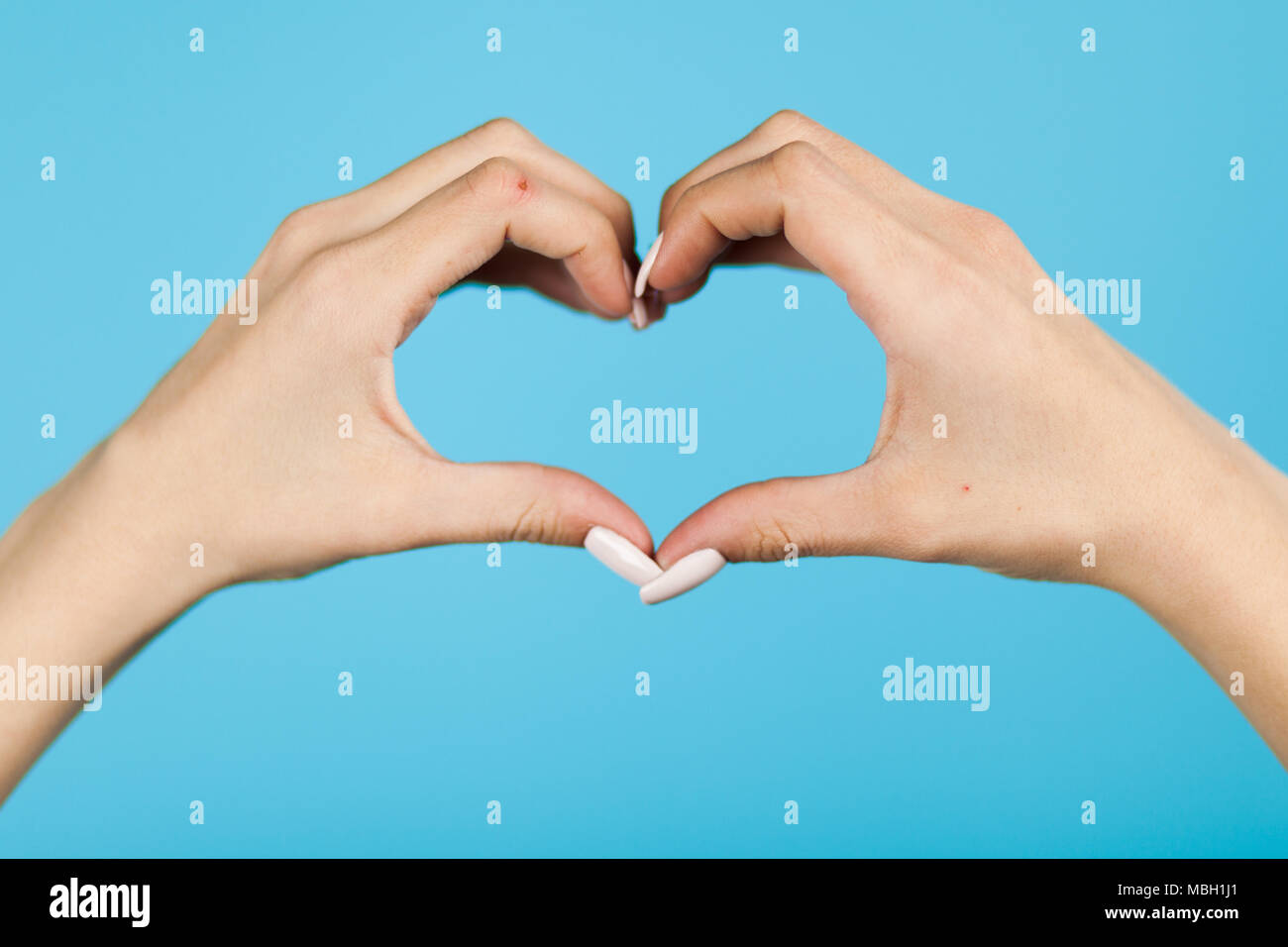 Female hands showing heart sign Stock Photo - Alamy