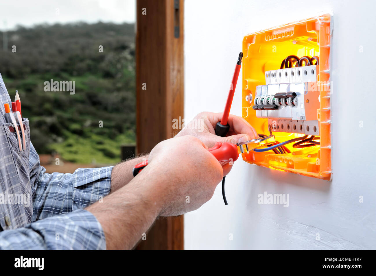Electrician technician working on a residential electric panel ...