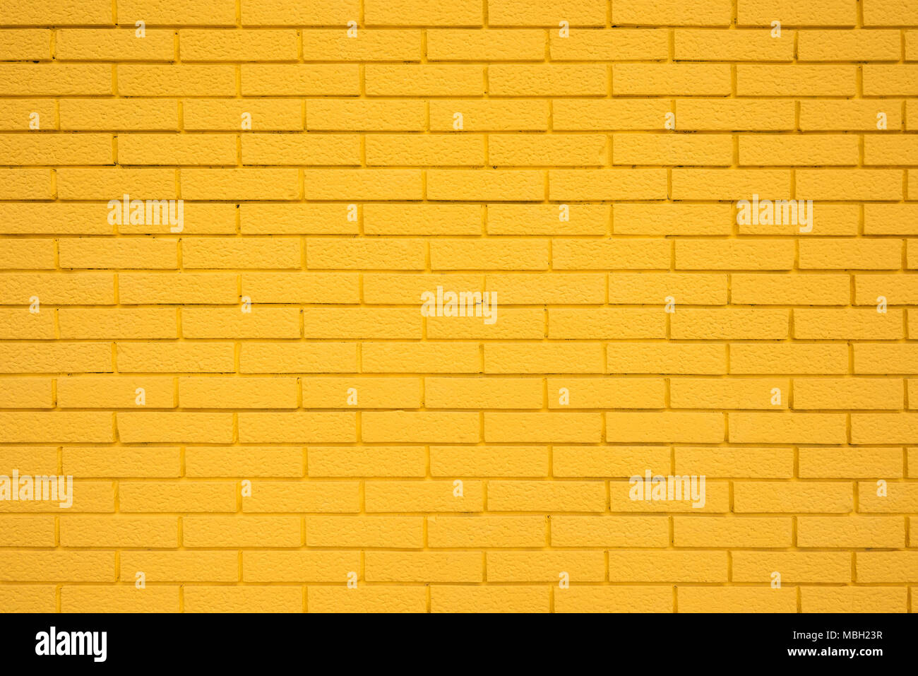 Yellow brick wall texture as background and copy space Stock Photo - Alamy