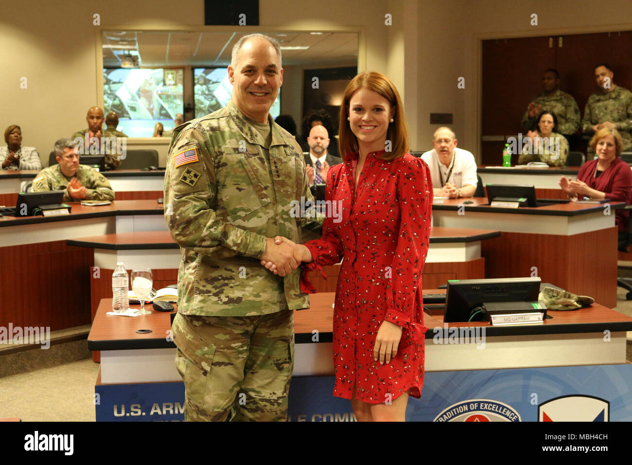 Army Materiel Command’s Commander Gen. Gus Perna presents a recognition ...
