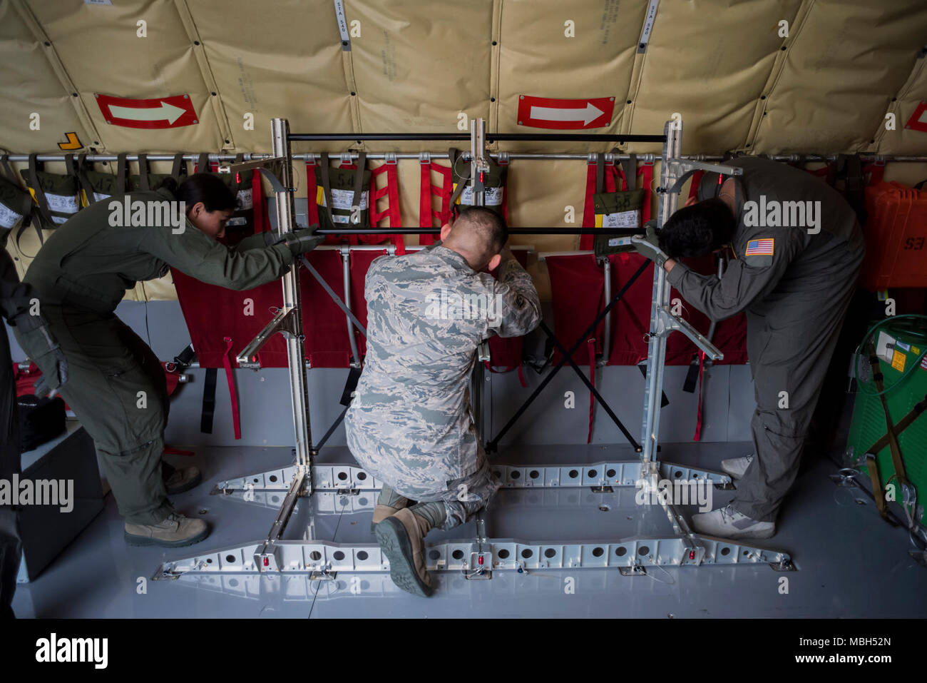 Aeromedical evacuation technicians assemble a stanchion litter system ...