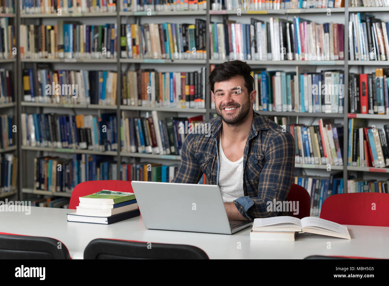 Portrait of an Attractive Student Doing Some School Work With a Laptop ...