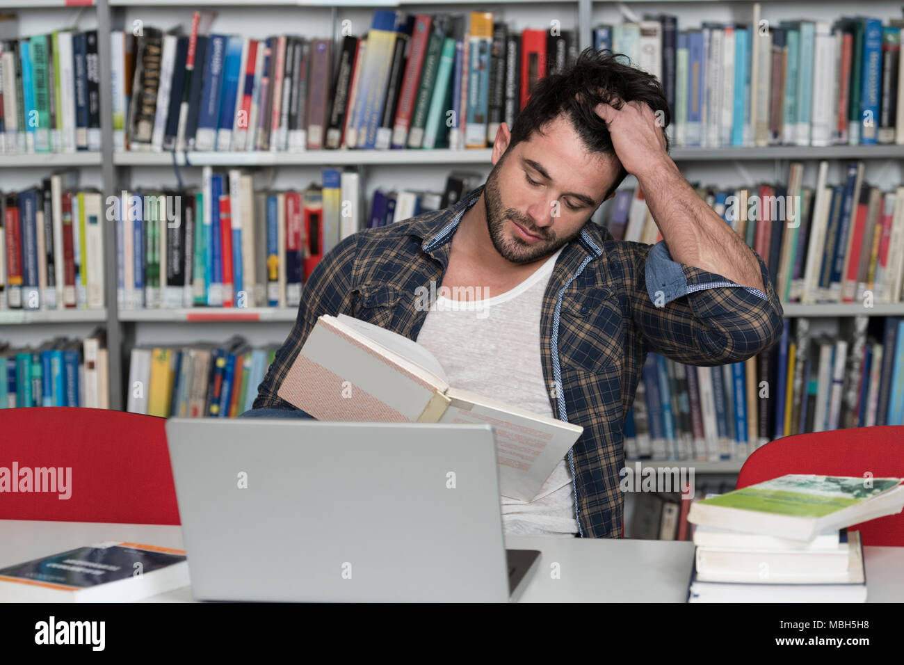 Stressed Student in High School Sitting at the Library Desk Stock Photo ...