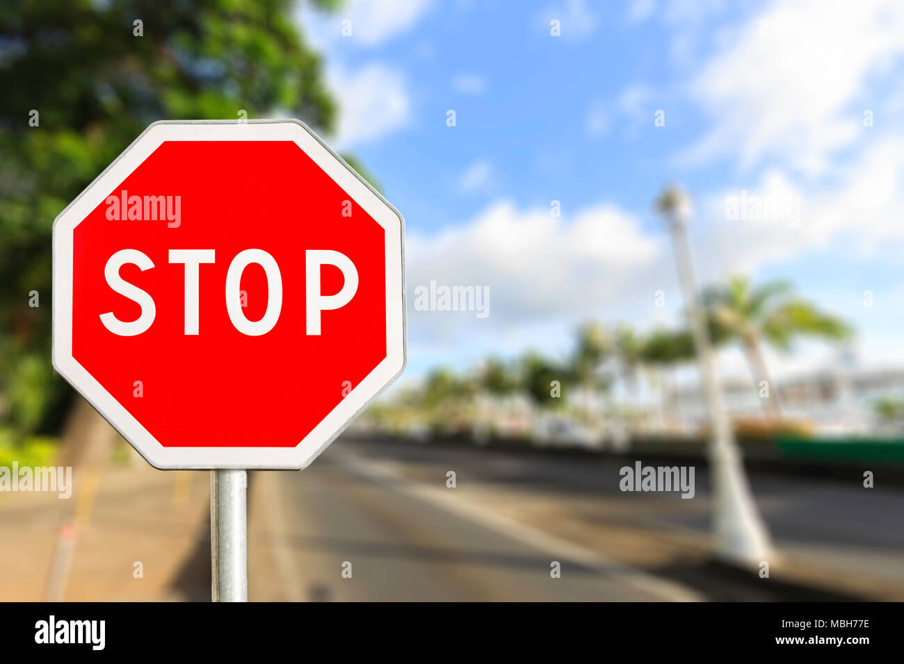 Stop sign by the City road Stock Photo - Alamy