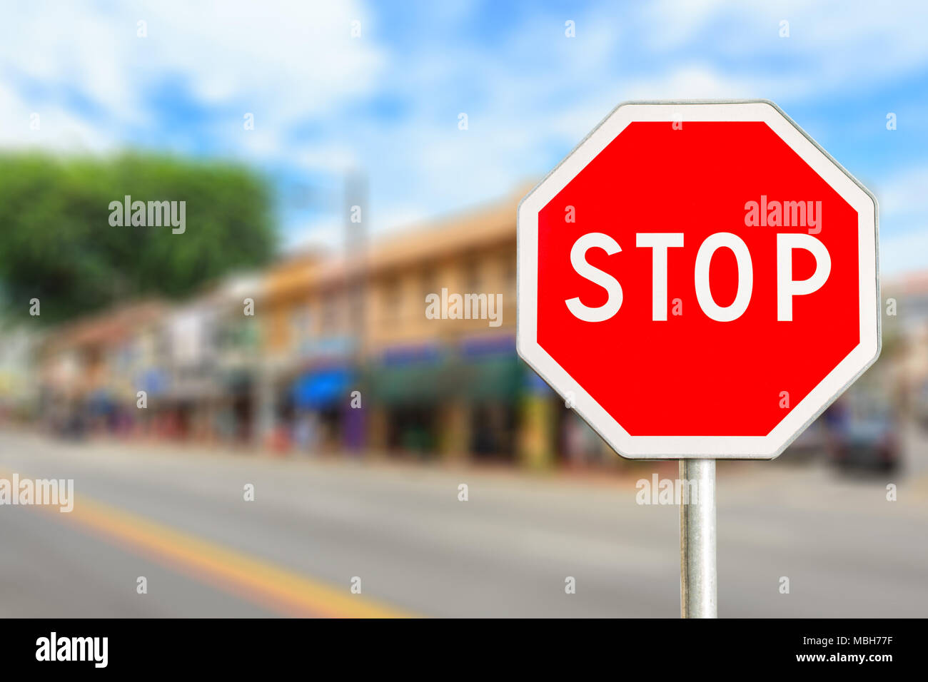 Stop sign by the City road Stock Photo - Alamy