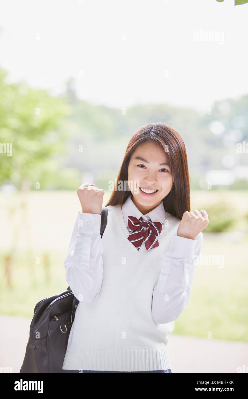Cute Japanese high school student in a city park Stock Photo - Alamy