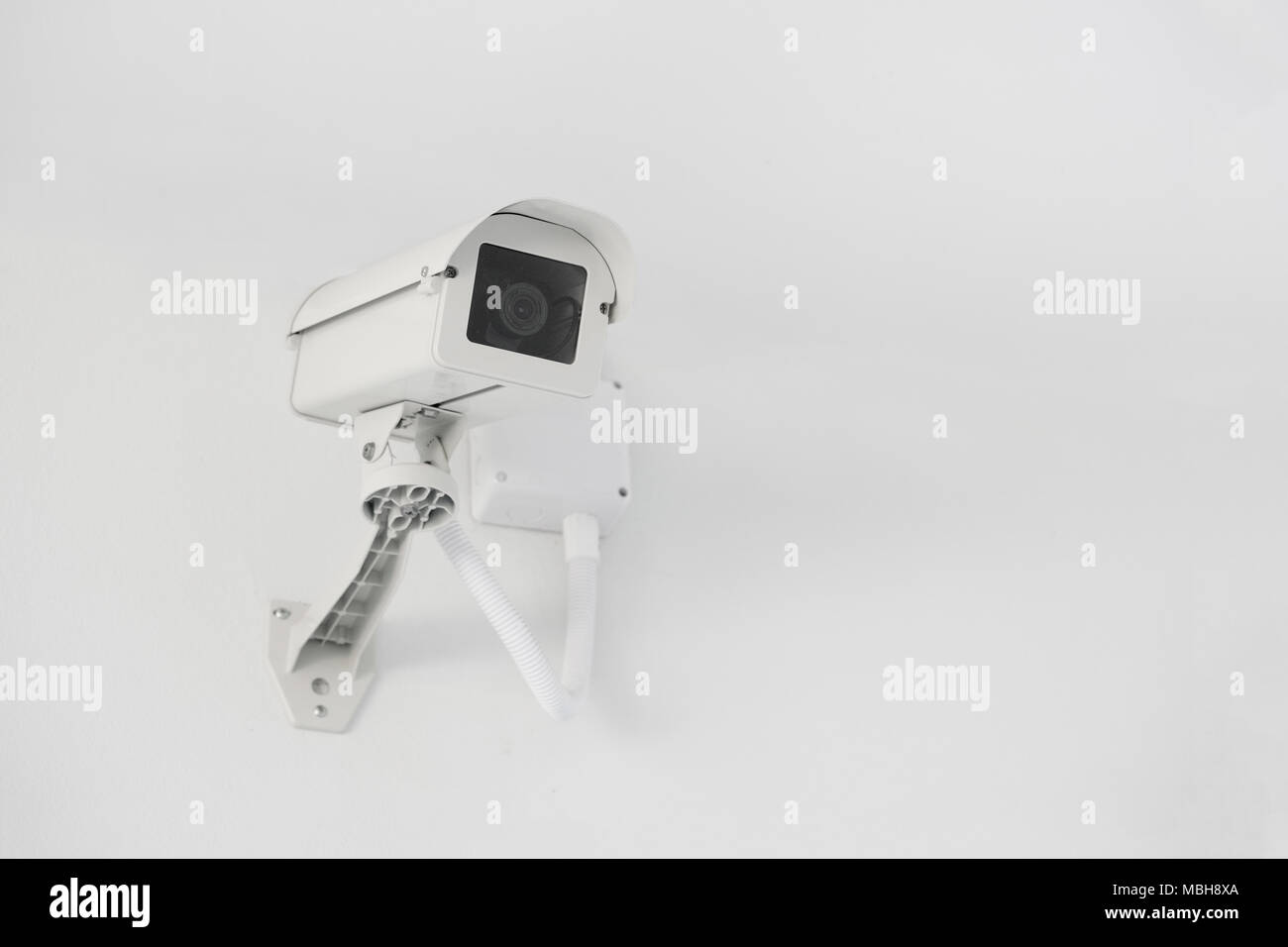 CCTV security camera installed on the building wall, operating indoor ...