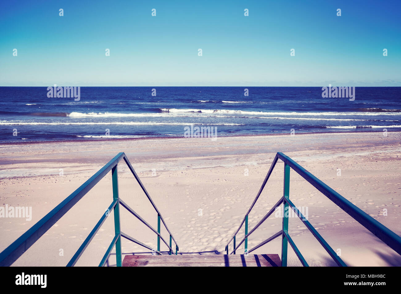 Stairs leading to an empty beach, color toned picture Stock Photo - Alamy
