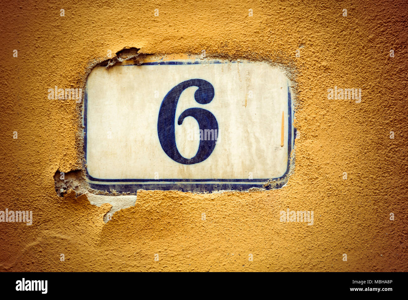 Number six enamel door number on plaster wall Stock Photo - Alamy