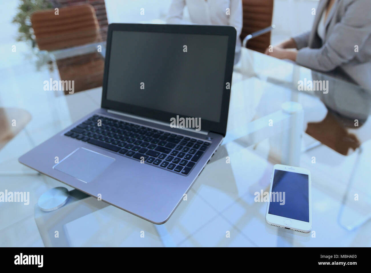 laptop and a smartphone on the desktop of a businessman. workplace ...