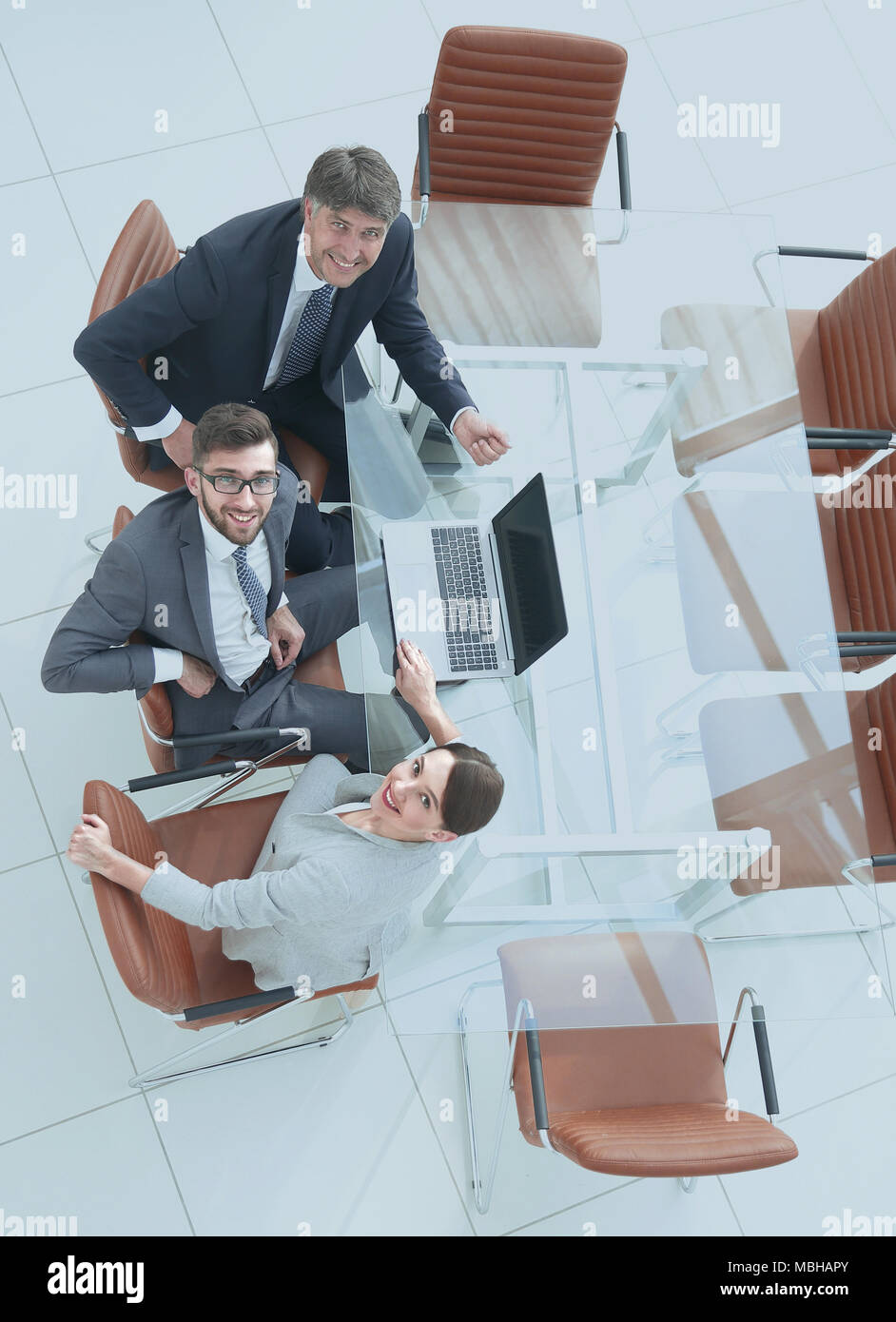 Top view .employees sitting at the desk and looking up Stock Photo - Alamy