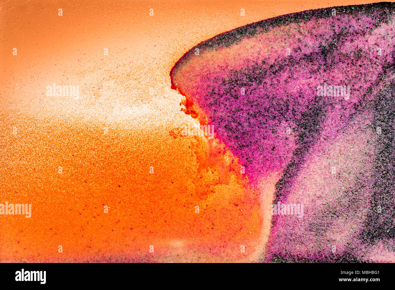Colorful sand pigments falling down in water. Abstract landscape ...