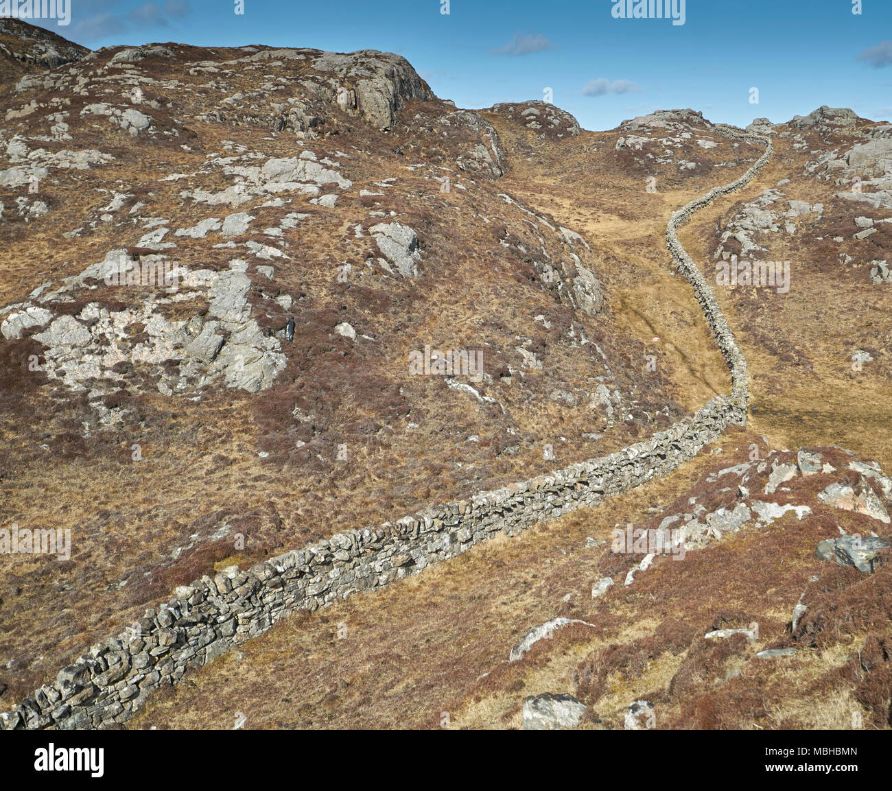 Unusual stone wall constructed of granite boulders winds its way ...