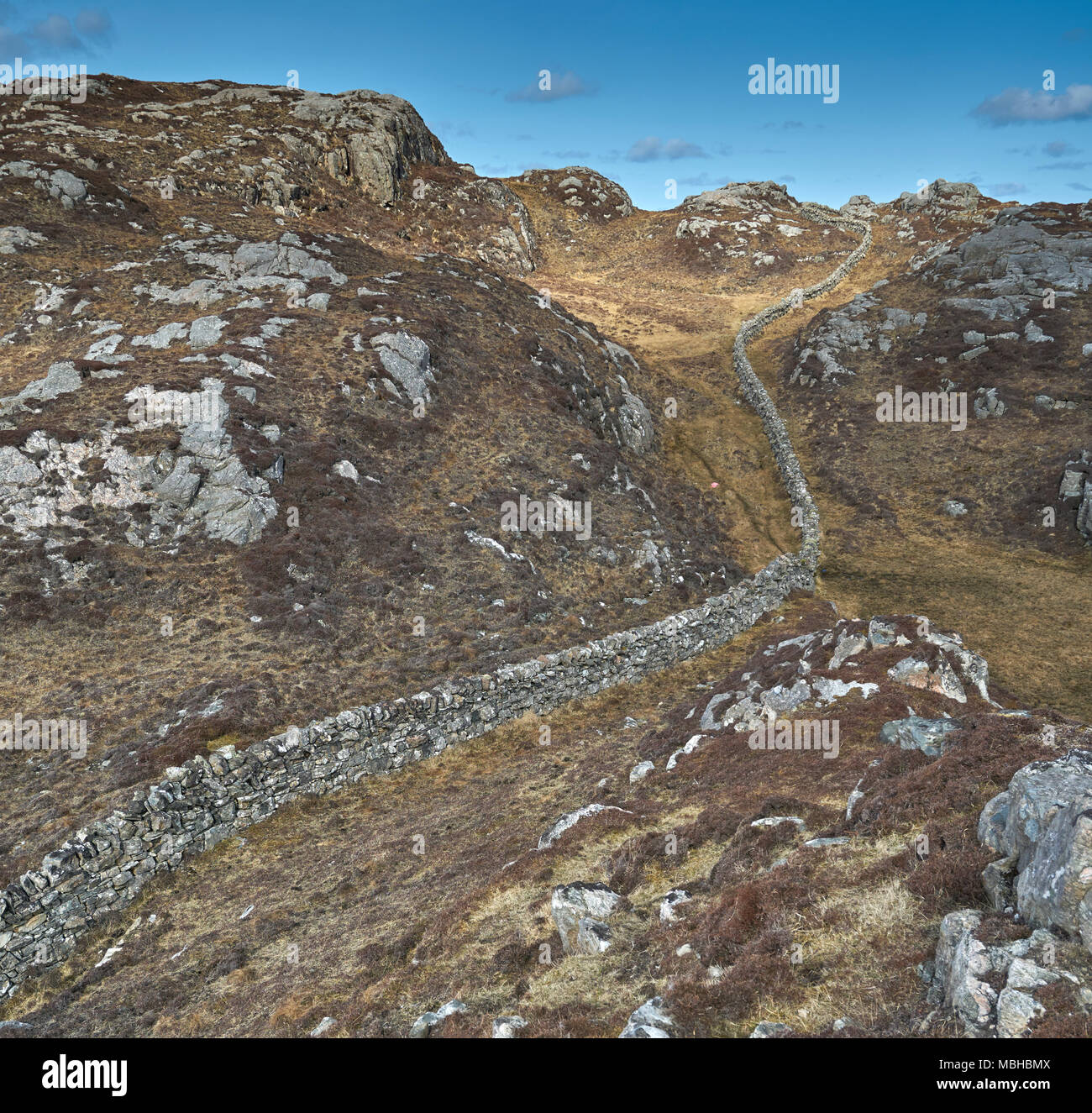 Unusual stone wall constructed of granite boulders winds its way ...