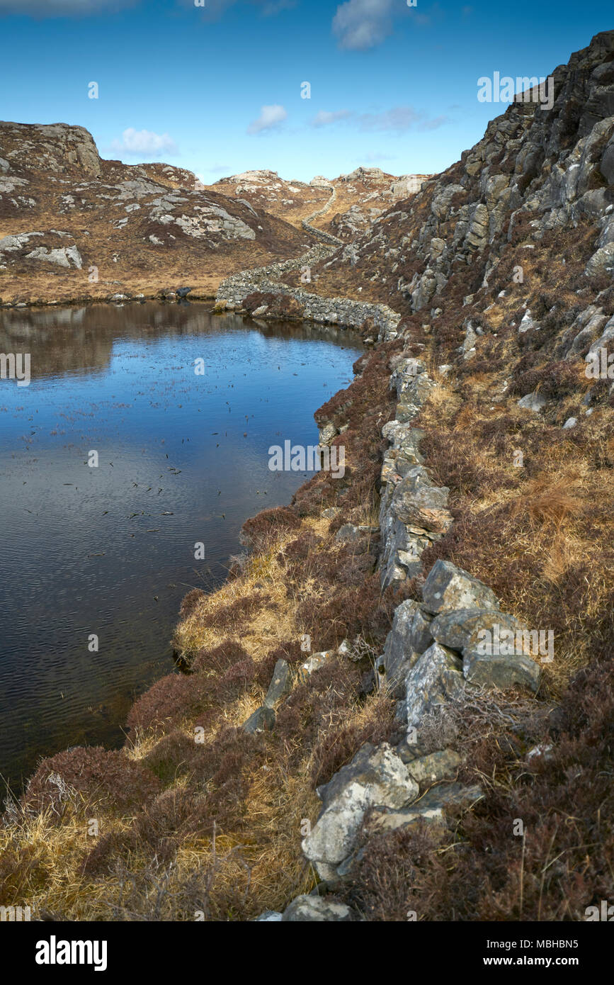 Unusual stone wall constructed of granite boulders winds its way ...