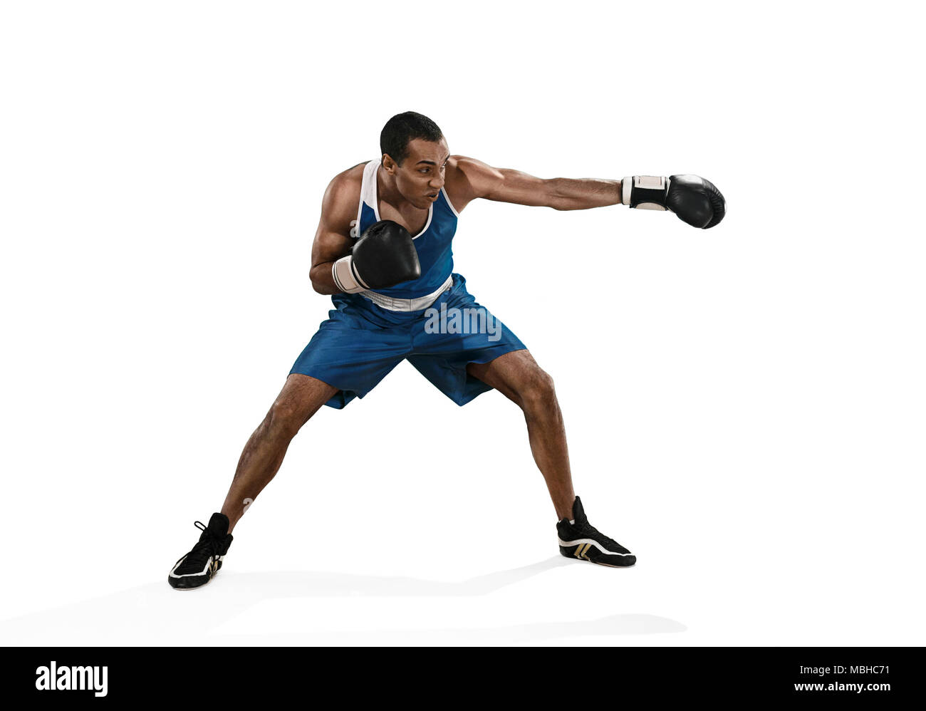 Sporty man during boxing exercise making hit. Photo of boxer on white ...